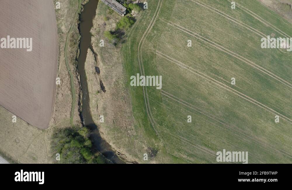 Bird's eye view following a river, then a bridge leading to nowhere ...
