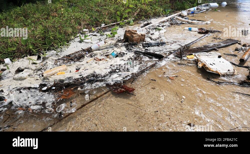Rubbish and waste on ocean coast. Polluted sea water damaging nature ...