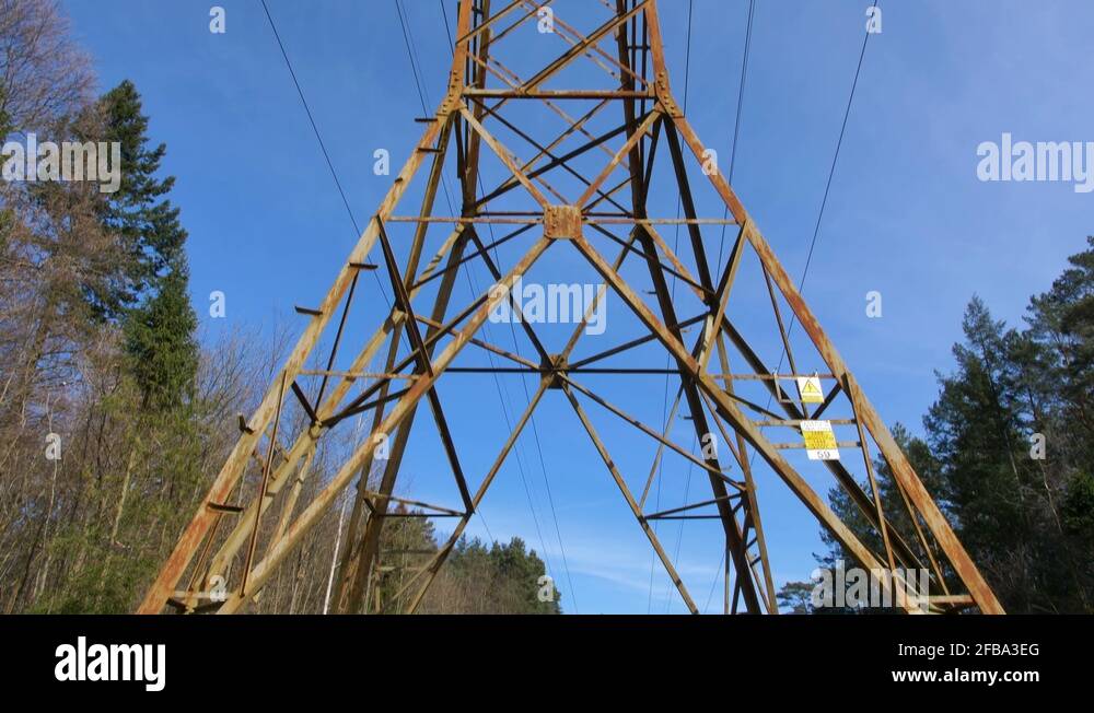 Old Rusty Transmission Tower and High Voltage Power Lines on Blue Sky ...
