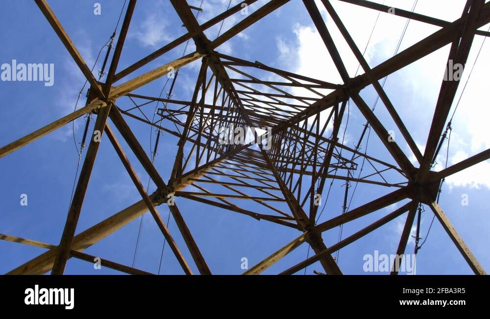 Old Rusty Transmission Tower and High Voltage Power Lines on Blue Sky ...
