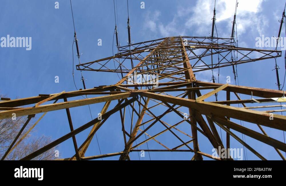 Old Rusty Transmission Tower and High Voltage Power Lines on Blue Sky ...