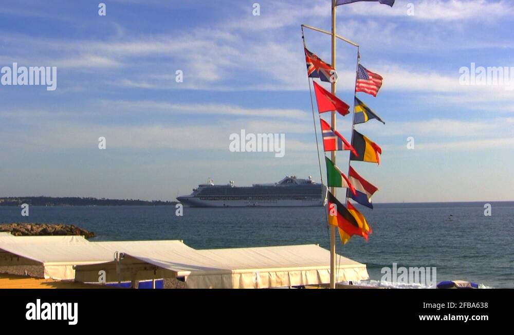 A mass of colorful, international flags wave in the ocean breeze as a ...