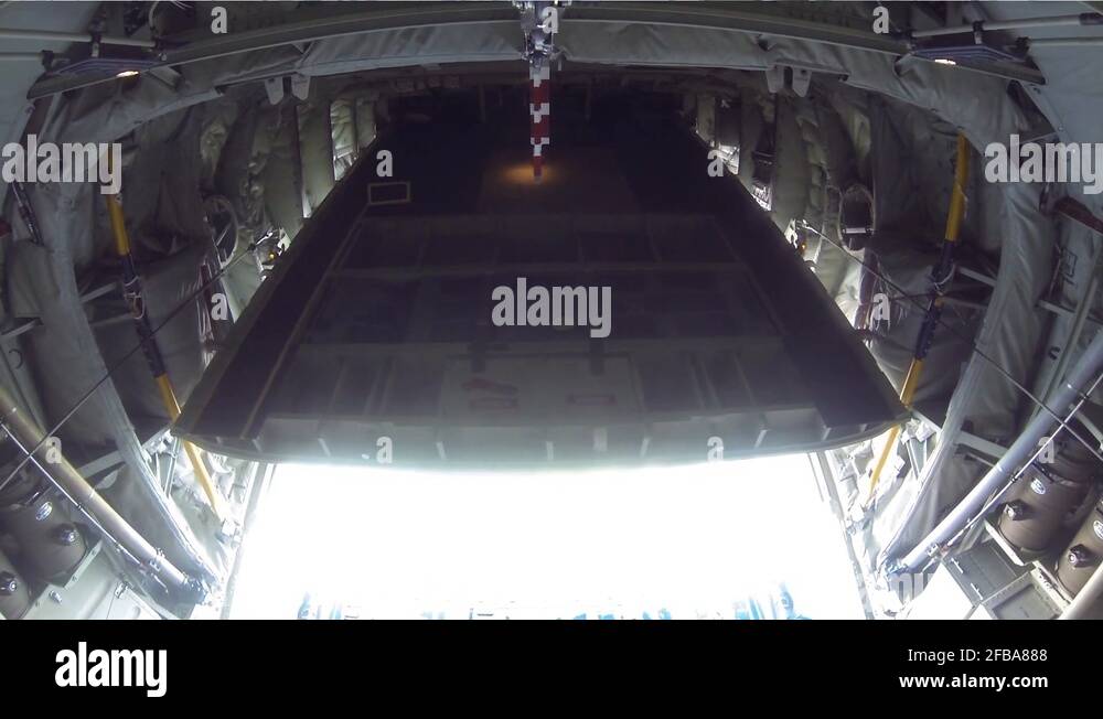 The cargo door of a C-130 opening and preparing cargo for aerial drop ...