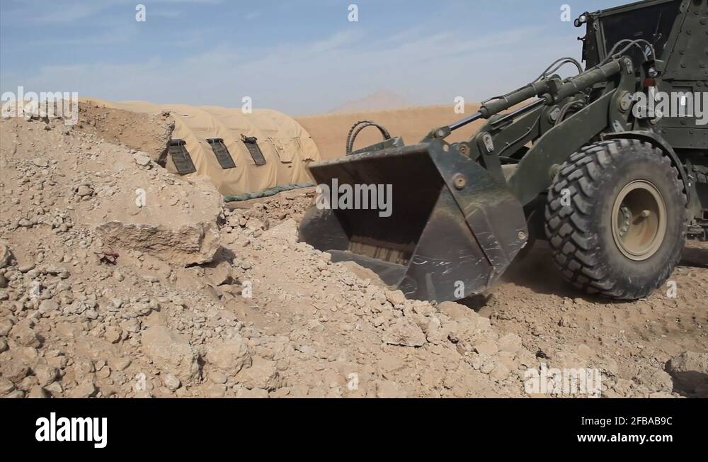 Marines breaking down mud walls with Armored wheel loader in Musa Qal ...