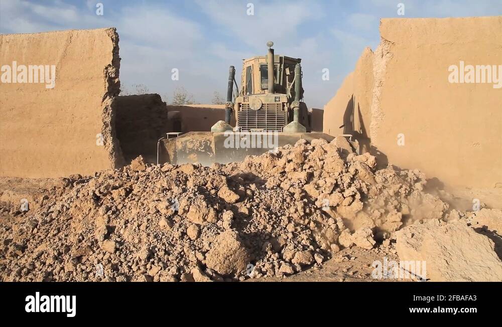 Marines breaking down mud walls with Armored wheel loader in Musa Qal ...