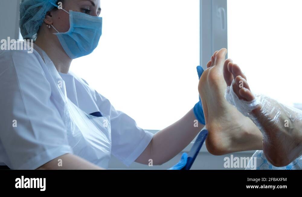 Girl cleans the old layer of skin with a foot tread - pedicure in the ...
