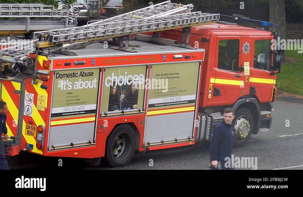 UK fire crew crossing street in urban scene from elevated perspective ...