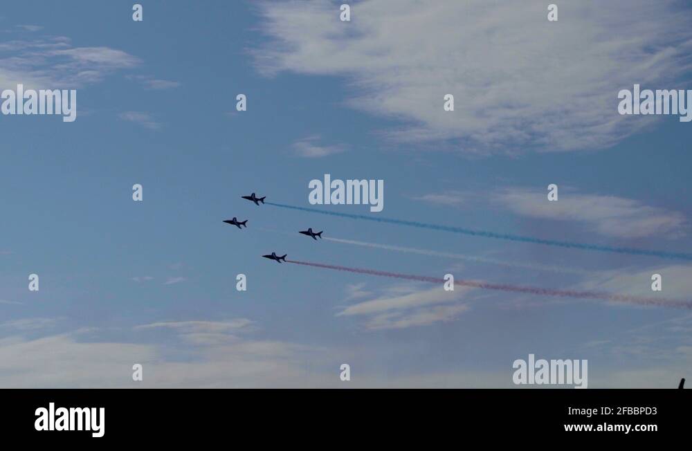 Fighter jets with colorful smoke flying in the blue sky during the ...