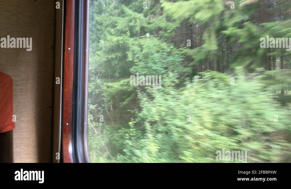 Looking through the windows of an old orange train / railcar that ...