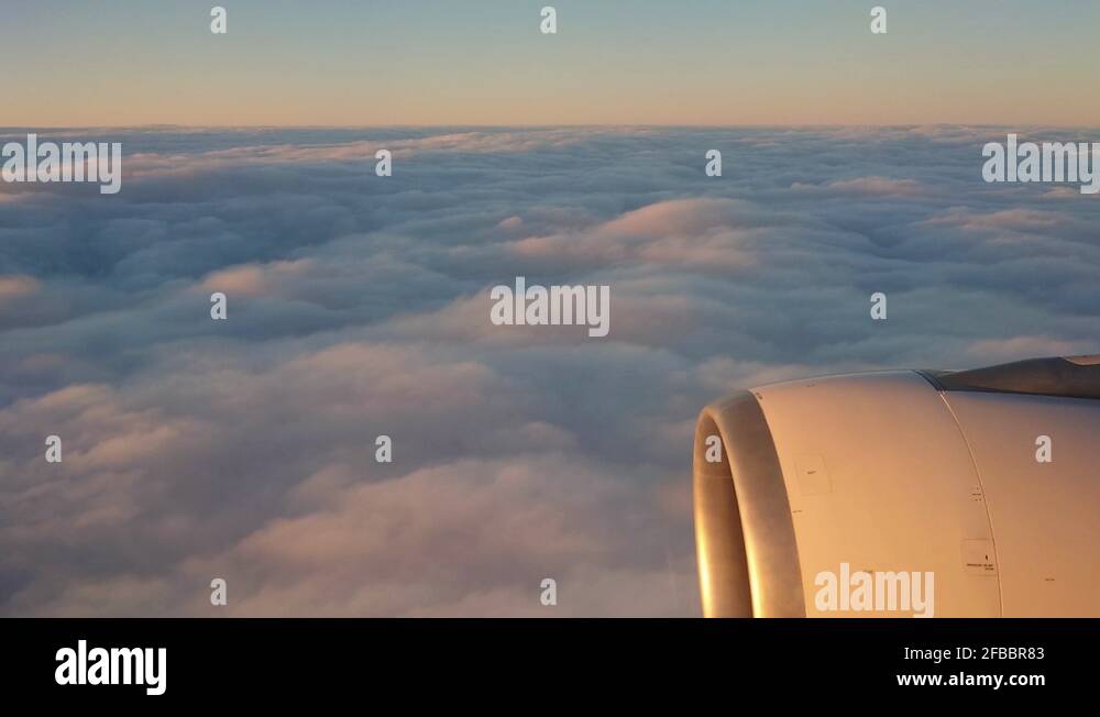 Aeral view from above the clouds on board of a jet airplane A330. One ...
