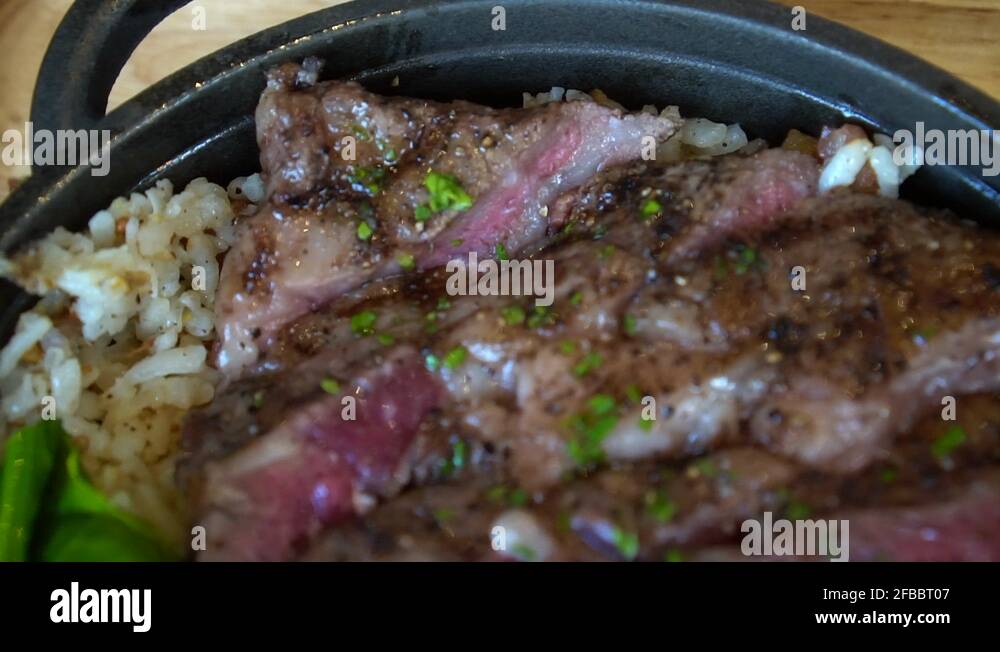 Medium rare wagyu premium beef roasted over rice Stock Video Footage ...