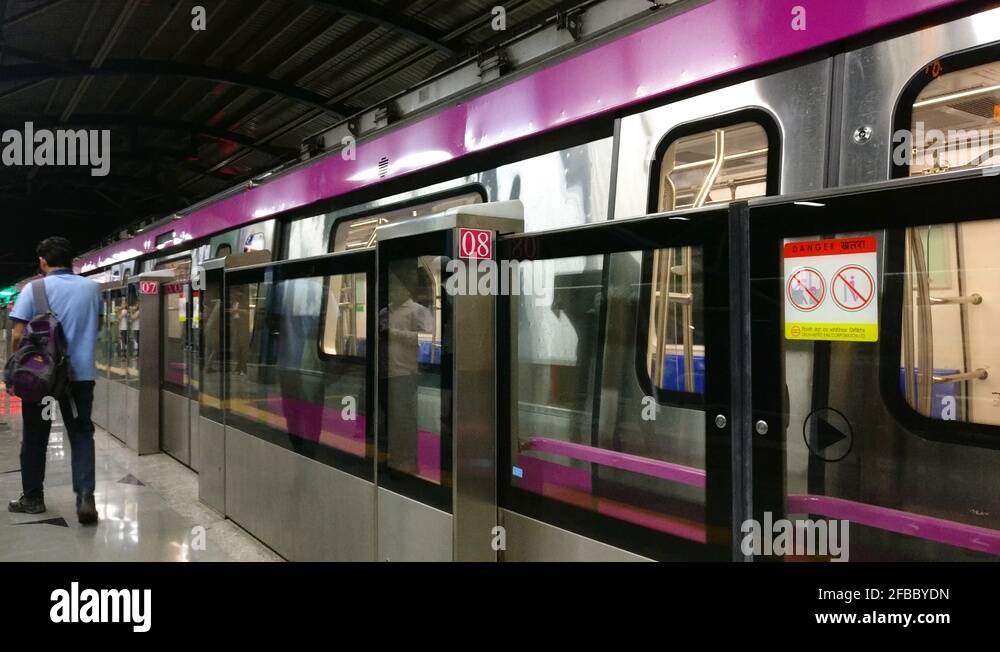 Man walking in front of safety gates of empty metro train on the violet ...