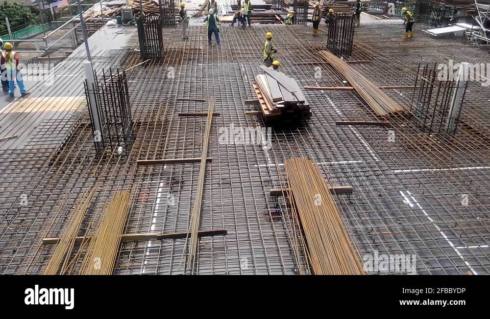Construction workers fabricating steel reinforcement bar to form Stock ...