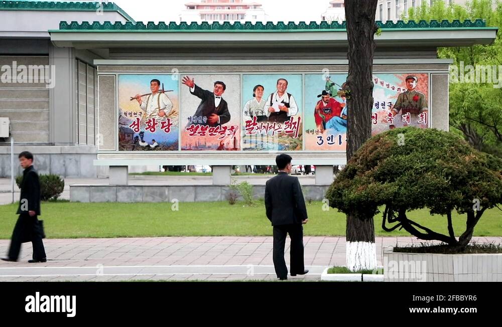 Propaganda Poster in Pyongyang with a North Korean Man in traditional ...