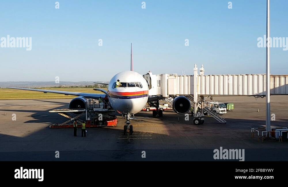 A Man Is Cleaning The Windows Of This Airplane Boeing 767 Connected To ...