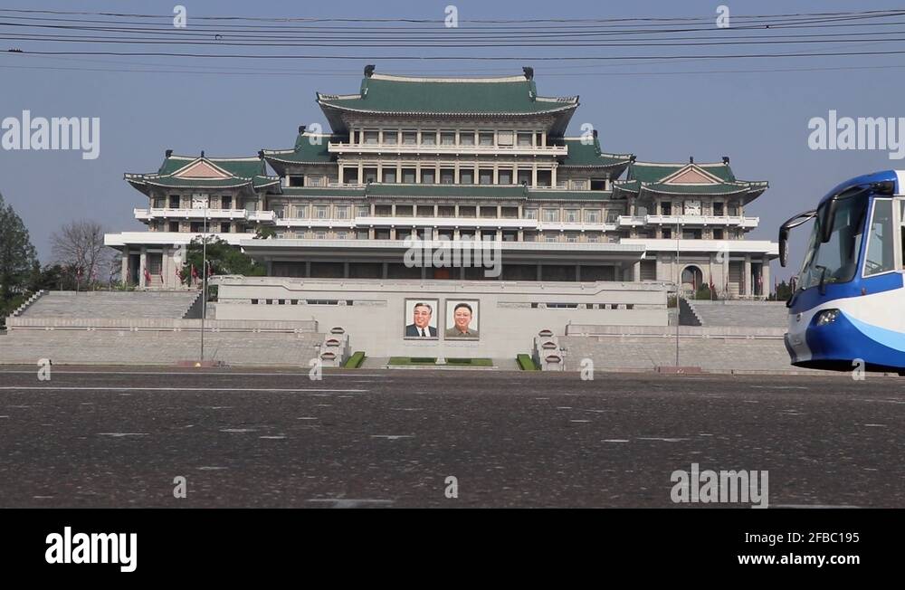 Angled shot of the Kim Il Sung Square in Pyongyang, as a trolley bus ...
