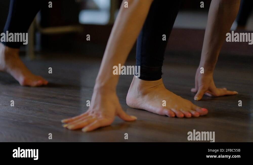 woman dancer shows position standing barefoot and bending body to floor ...