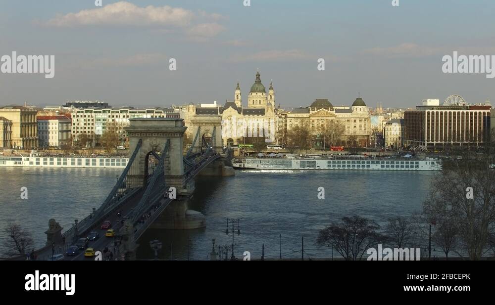 The Chain Bridge in shadow while the St. Stephen's Basilica in the ...
