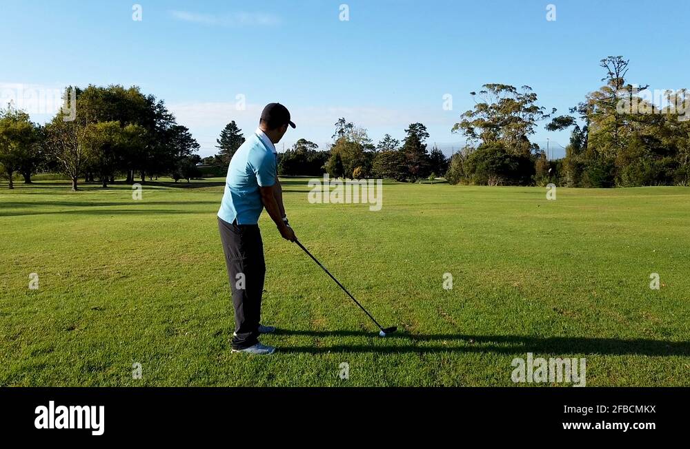 Man on golf course with wood swing and hitting the ball Stock Video ...