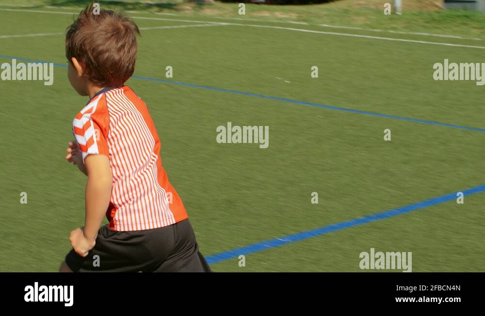 Little boy playing soccer, falling and crying in football field, 4k ...