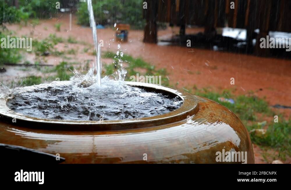 Rain water falling into a clay pot in a village in Cambodia Stock Video ...