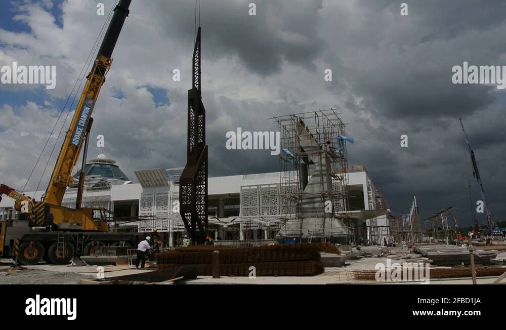 Mobile crane lifting heavy steel structure at the construction site ...