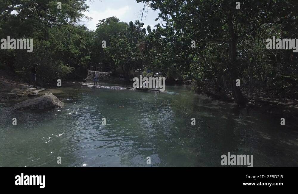 river rafters coming to the end of their journey on a Jamaican river ...
