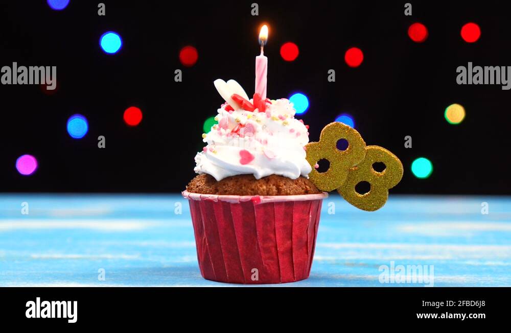 Delicious birthday cupcake with burning candle and number 88 on ...