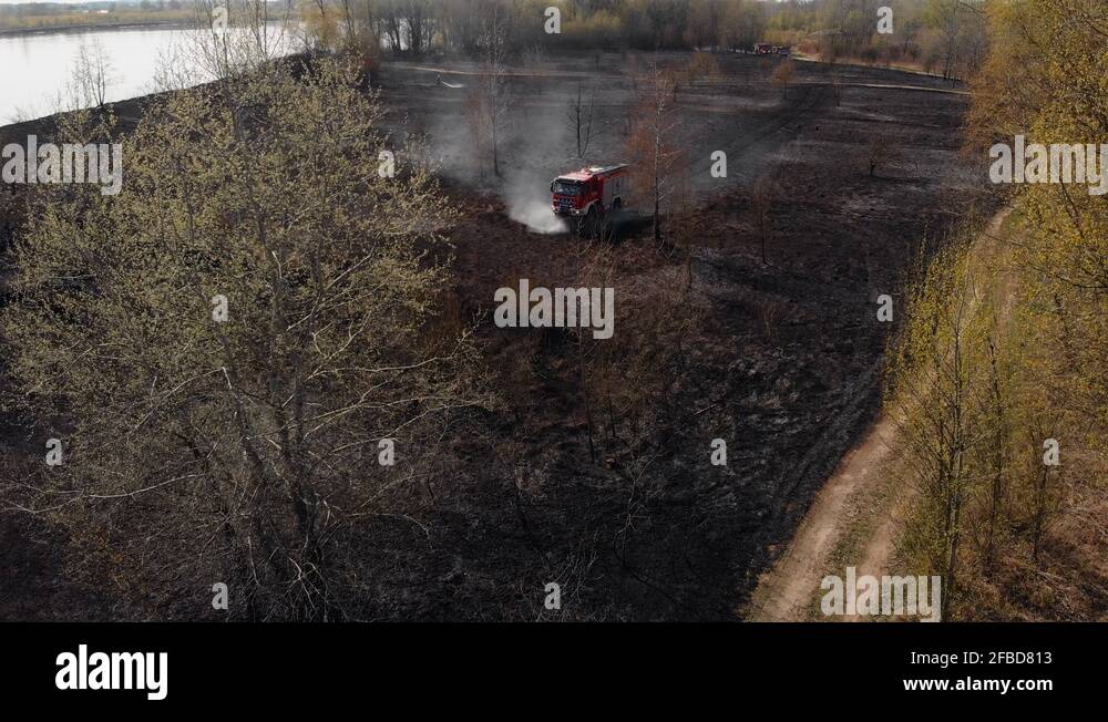 Firetruck Extinguishing aWildfire Fire. Extinguishing Burning Grass ...