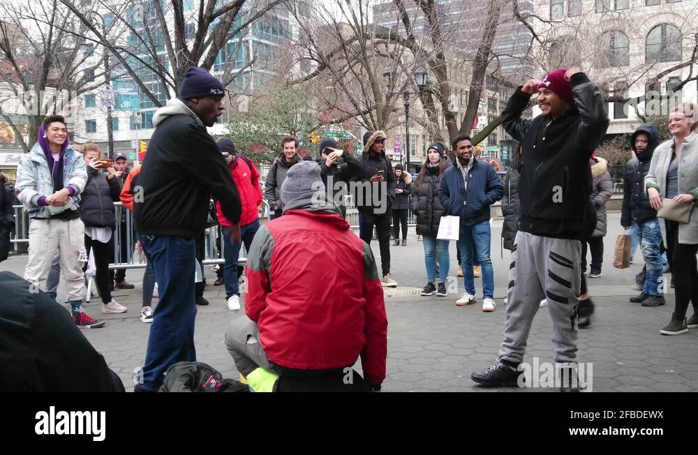 Two Rappers a drums player and large group of people watching the show ...