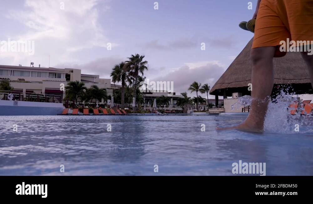Two people walking around in a pool Stock Video Footage - Alamy
