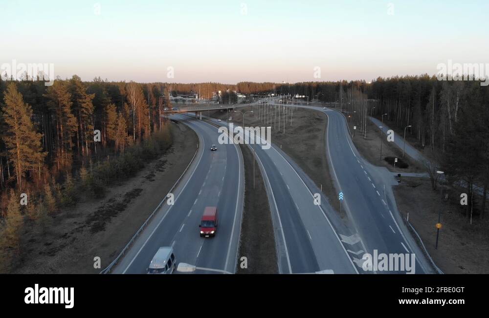 Aerial, reverse, drone shot, of cars, on a motorway, a petrol station ...
