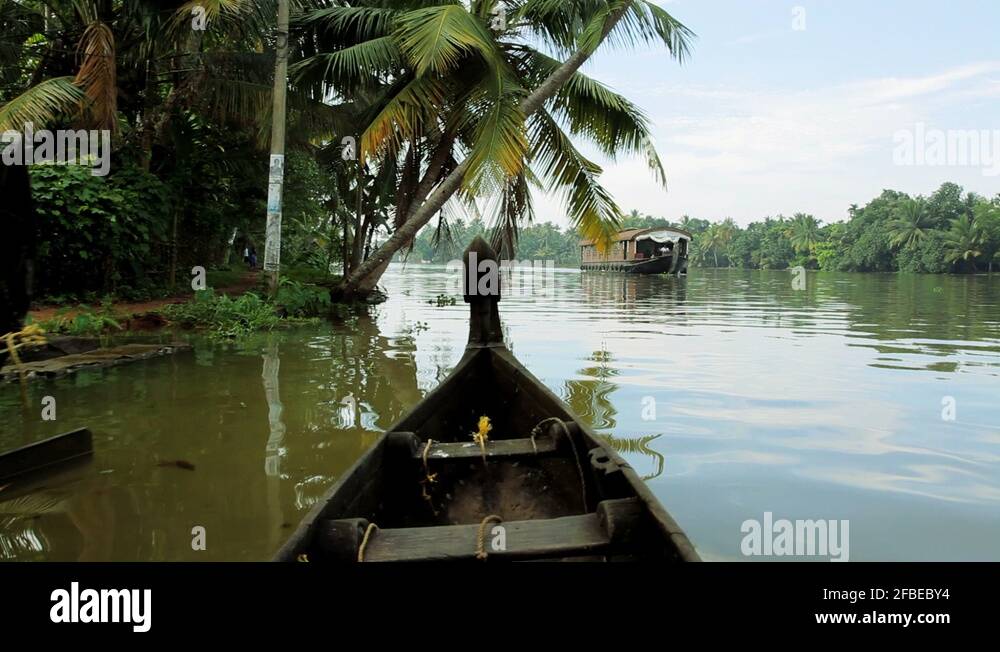 Canoe traveling passed Traditional houseboat, Kerala backwater, Kerala ...