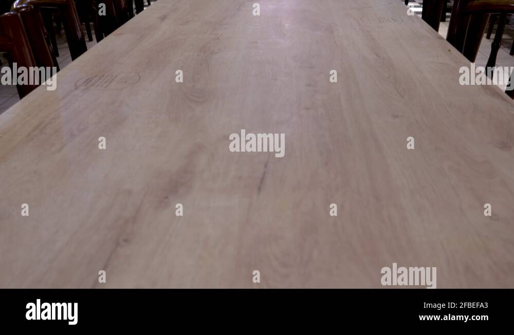 Tilting up shot from large wooden table surface inside Singapore's ...