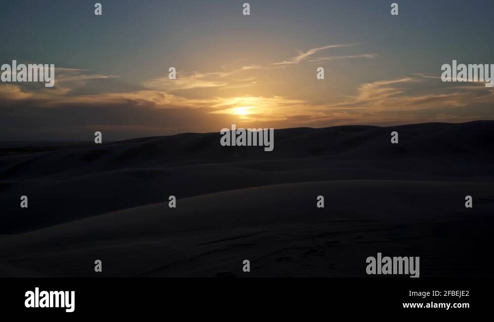 Sun setting over the hot harsh desert caused by global warming climate ...