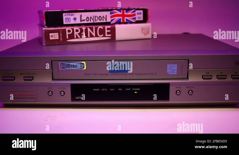 Inserting VHS London Video Tape Into A VCR Player. Prince Video ...