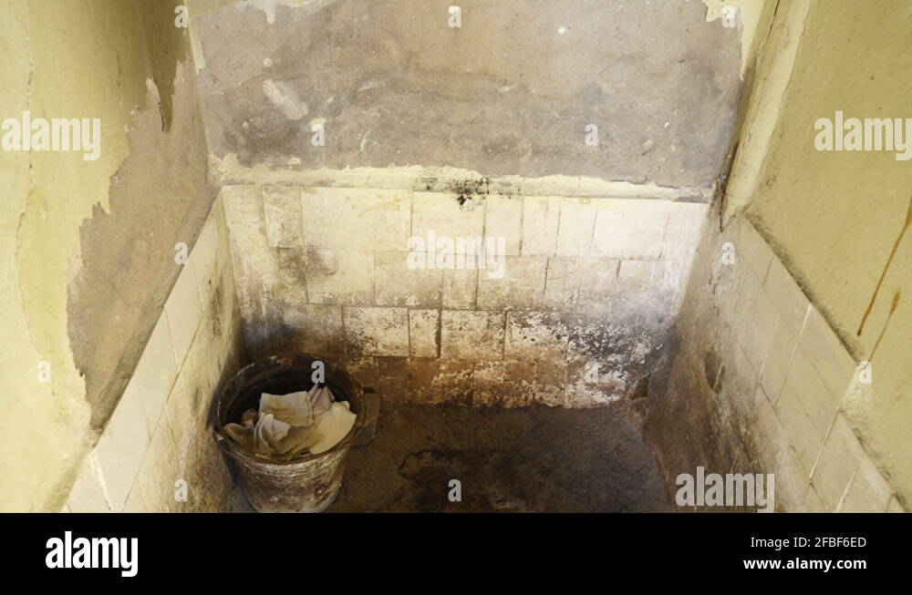 Dirty public outhouse with squat toilet and pit latrine first person ...