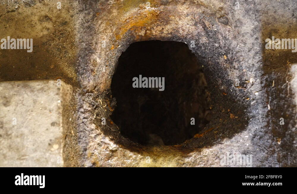 Pit latrine in dirty outhouse. Human feces in a hole in the ground ...