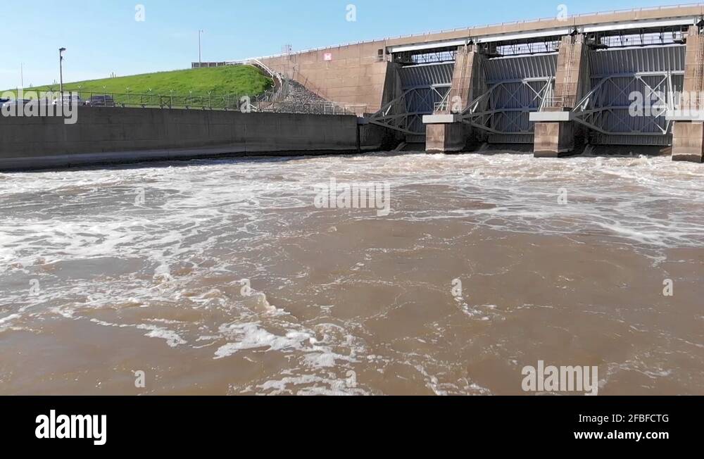 Tracking towards a spillway displacing water from a dam Stock Video ...