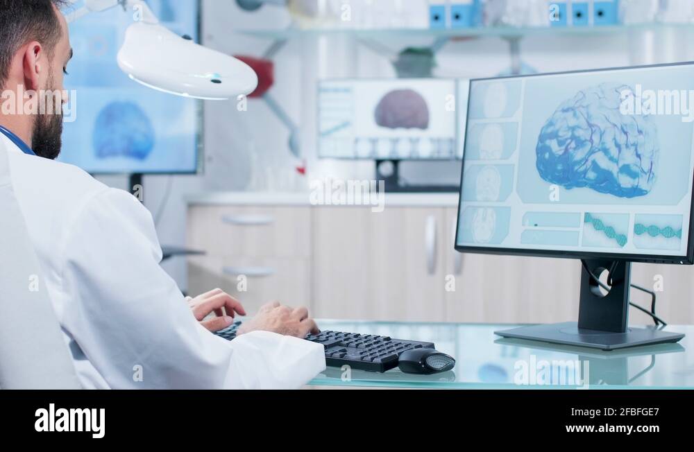 Researcher in medicine field typing in computer keyboard, looking at X ...