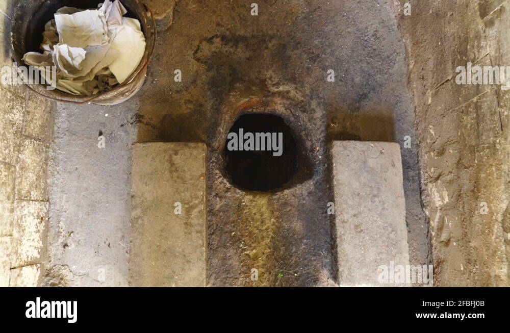 Pit latrine in dirty outhouse. Human feces in a hole in the ground ...