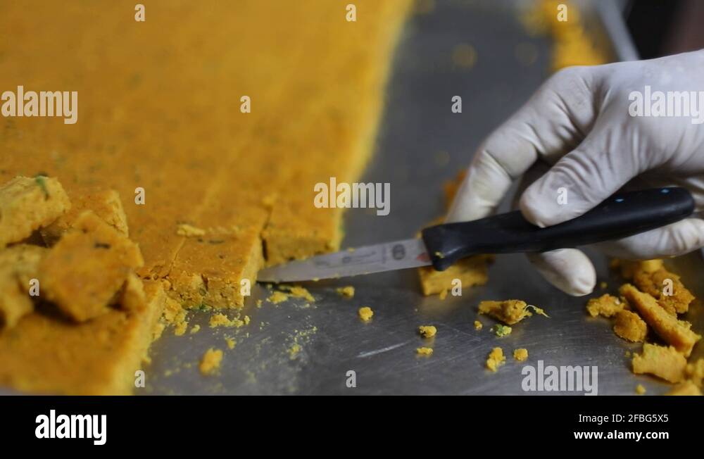 Full HD video of Chef cutting Indian sweets into slices inside a Stock ...