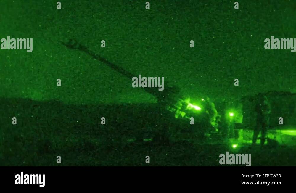 Night vision imagery of soldiers firing M777 Howitzer in Iraq Stock ...