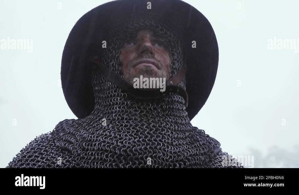 Close up of a medieval soldier in chainmail armor with a sword in the ...
