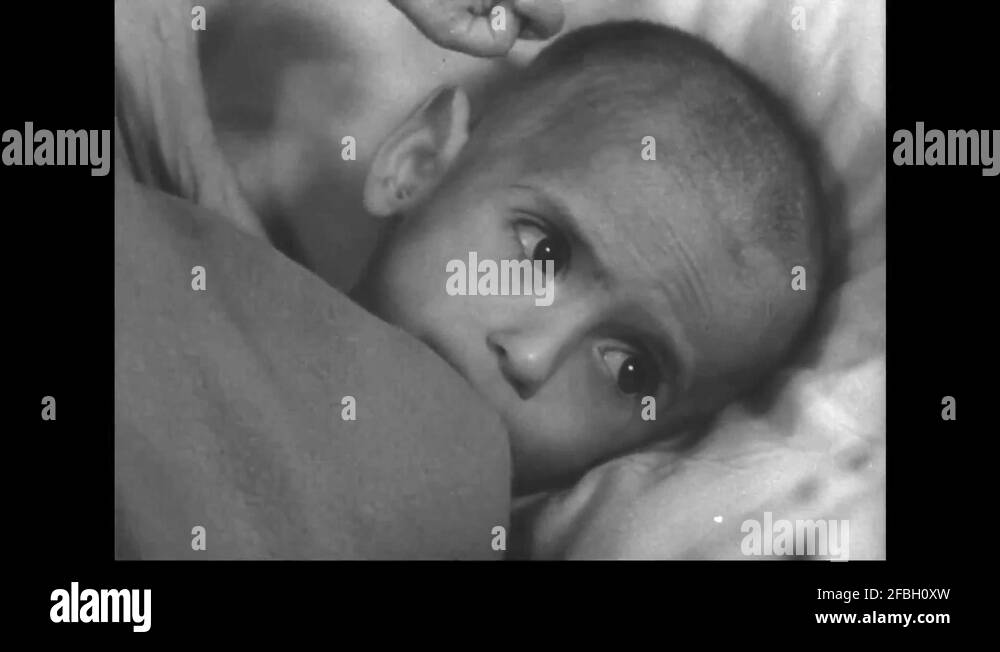 WW2 - Underfed children lay in bed Stock Video Footage - Alamy