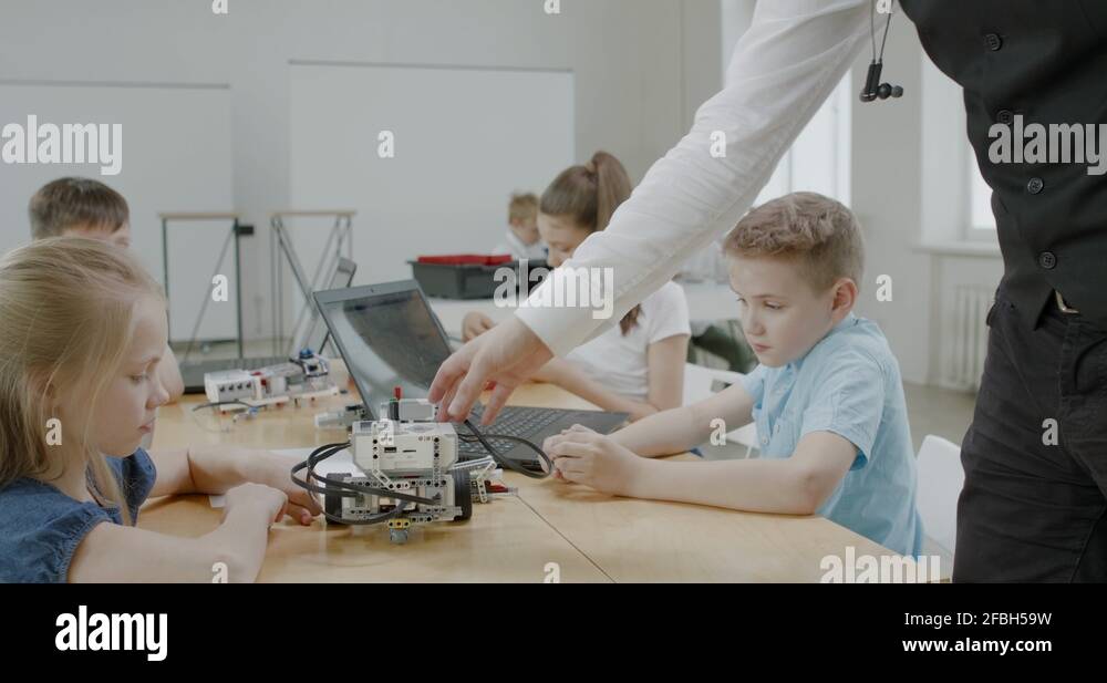 Curious kids working on a programable robot during robotics class at school Stock Video Footage ...