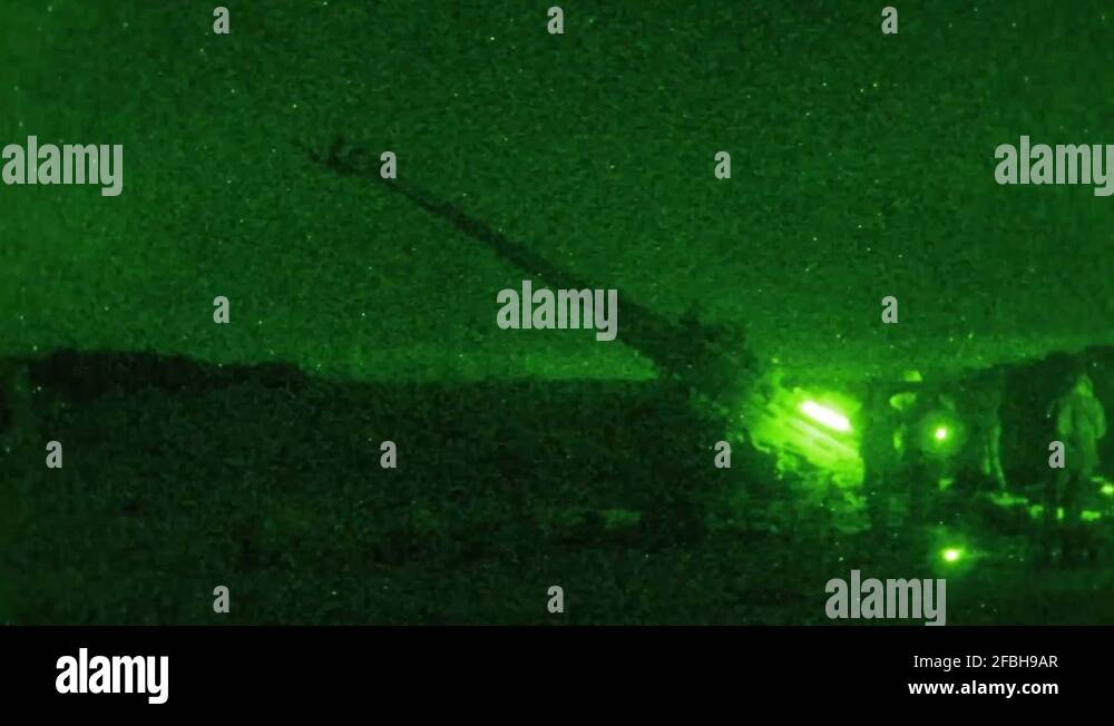 Night vision imagery of soldiers firing M777 Howitzer in Iraq Stock ...