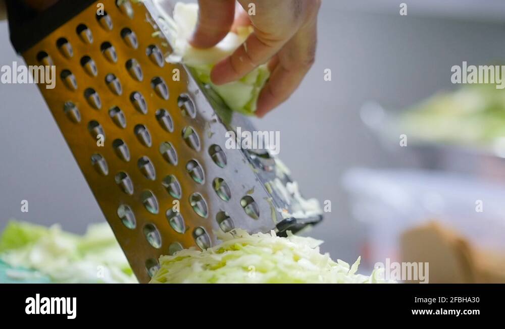 Close-up shredding cabbage with a grater Stock Video Footage - Alamy