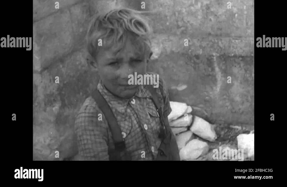 WW2 - Boy carry two children with trolley Stock Video Footage - Alamy