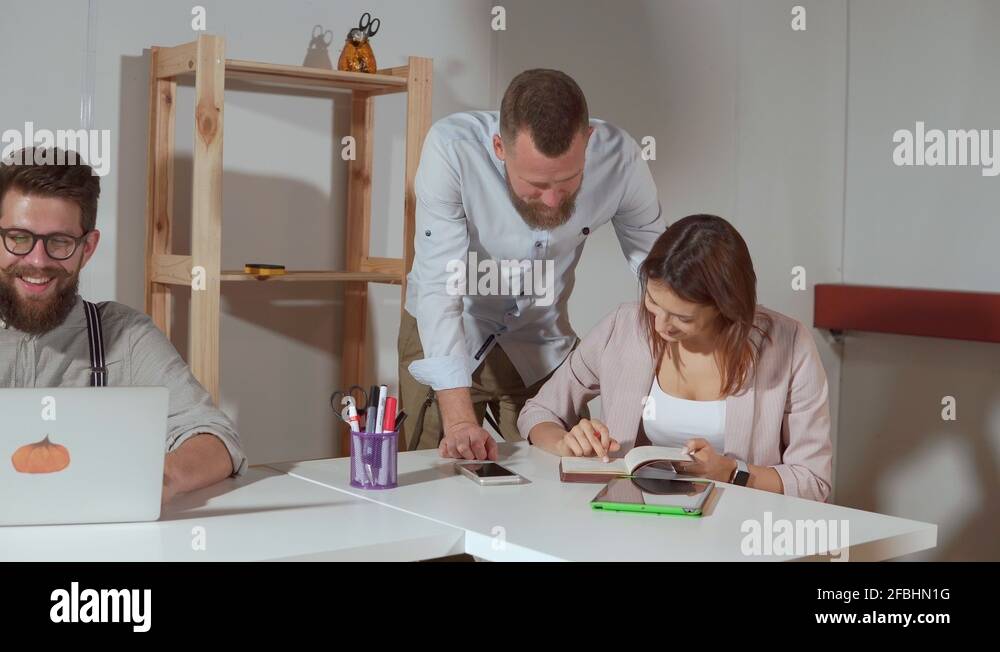 Guy helping others at work Stock Video Footage - Alamy